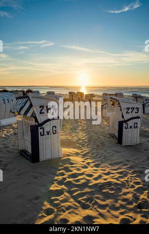 White beach chairs and mudflats, sunset, Duhnen, Cuxhaven, North Sea ...