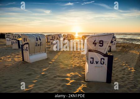 White beach chairs and mudflats, sunset, Duhnen, Cuxhaven, North Sea ...