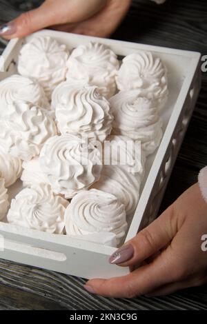 Homemade zephyr. A woman is holding a tray of marshmallows Stock Photo ...