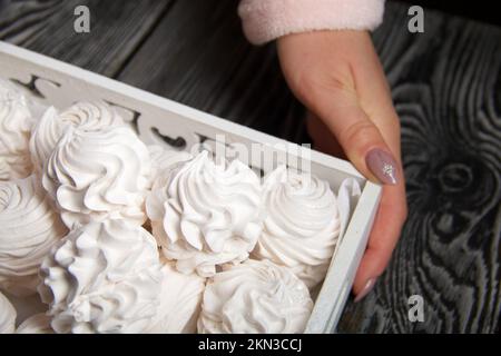 Homemade zephyr. A woman is holding a tray of marshmallows Stock Photo ...