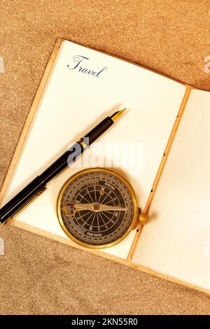 Vintage expedition journal on a rustic picnic table with a candle ...