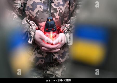 Ukrainian seviceman holds a candle. Candle in hands of Soldier Stock ...
