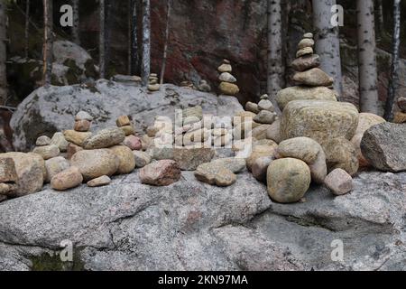 Many balancing stones stacked on a big stone Stock Photo - Alamy
