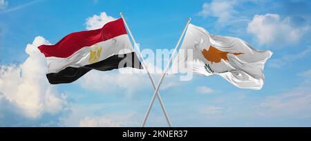 Cyprus and Egypt flags waving together on blue cloudy sky, two country ...