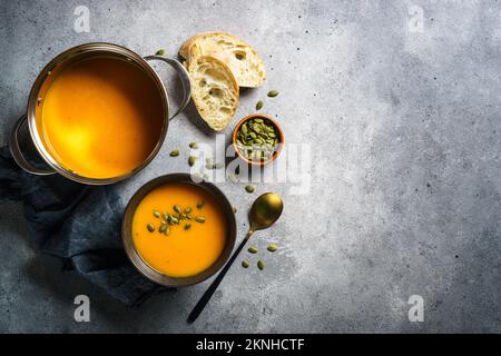 Pumpkin soup in the pot at stone table Stock Photo - Alamy