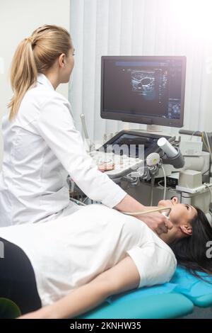 Smiling doctor, ultrasound. The doctor performed an ultrasound Stock ...