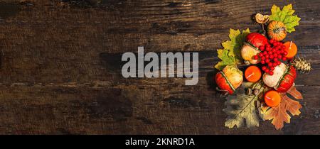 Autumn festive composition on old wooden background. Decorative pumpkin ...