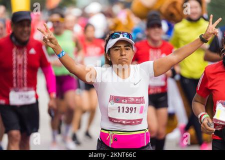 A woman running the International Marathon of Mexico city on the street ...