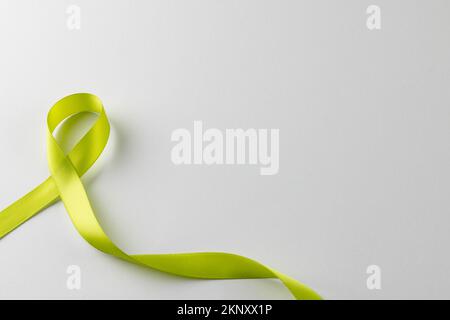 Composition of light green std health awareness ribbon, on white ...