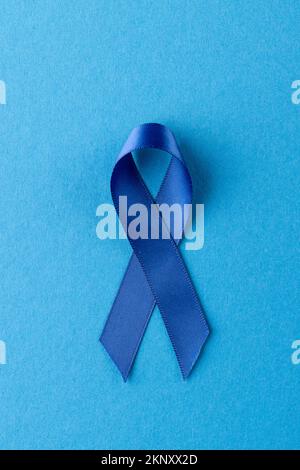 Vertical of blue ribbon for prostate cancer awareness, on blue ...