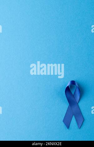 Vertical of blue ribbon for prostate cancer awareness, on blue ...