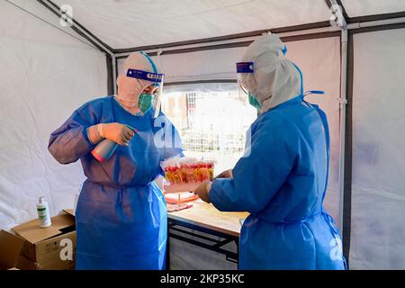 HOHHOT, CHINA - NOVEMBER 28, 2022 - Medical workers arrange nucleic ...