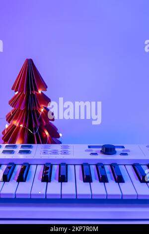 Christmas background with midi keyboard and holiday decor with neon ...