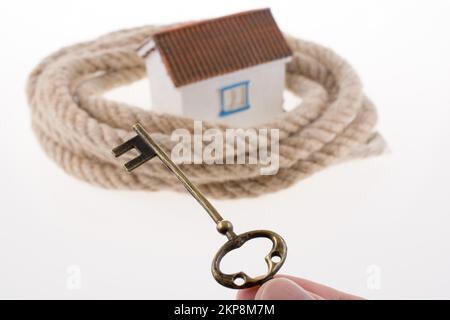 House surrounded by rope on a white background Stock Photo - Alamy