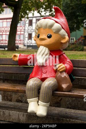Sculpture of the Sandman on a bench in front of half-timbered houses on ...