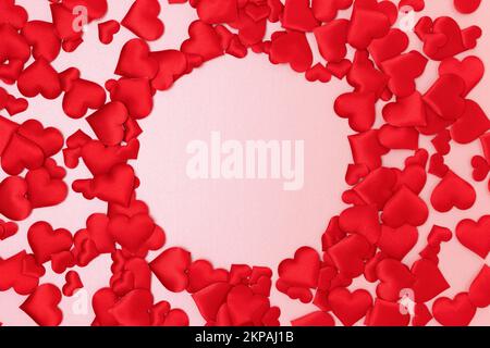 Round frame made of textile pink confetti in a heart shape. Monochrome ...