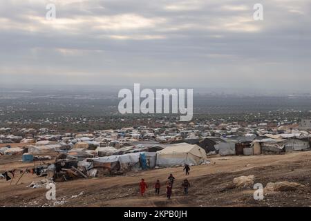 28 November 2022, Syria, Azaz: Syrian children stand at Bersaya refugee ...