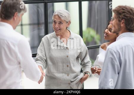 Conversation between managers and employees in the office Stock Photo ...