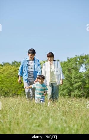 Japanese parents watching over running child Stock Photo - Alamy