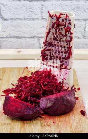 Metal kitchen grater with beets on a white background Stock Photo - Alamy
