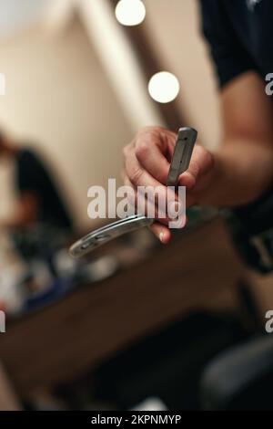barber hand testing the sharpness of blade Stock Photo - Alamy