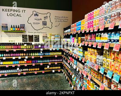 Alcohol aisle at Booths Supermarket, Ilkley. Shelves full of alcoholic ...