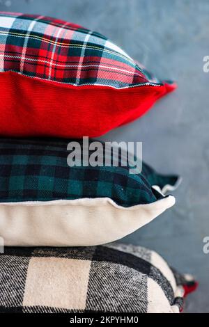 Close-up of a stack of assorted pillows with various checked patterns ...