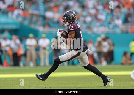 Houston Texans wide receiver Nico Collins, left, signs autographs for ...