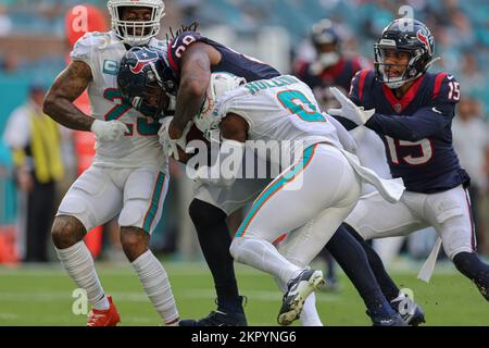 Miami Dolphins safety Jevon Holland, front left, attempts to tackle New ...