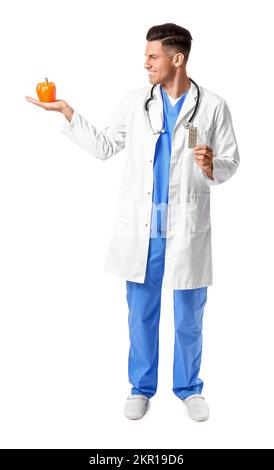 Male doctor with vitamins and bell pepper on white background, closeup ...