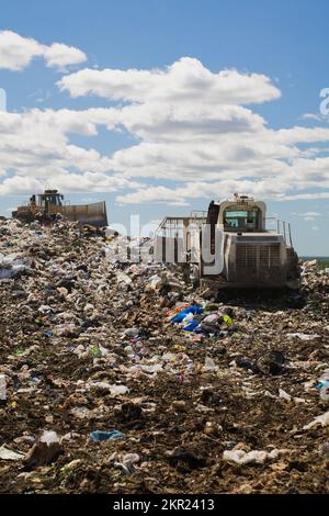 Terex TC550 landfill compactors spreading out and compacting discarded ...