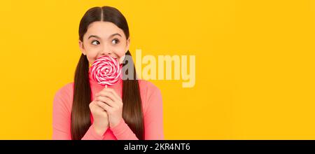Teenager girl eating sugar lollypop. Candy and sweets for kids. Child ...