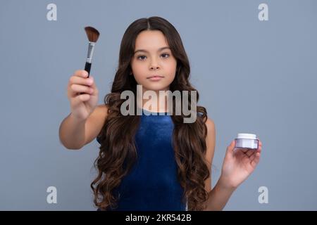 Kids make up products. Makeup teen child artist apply face powder with ...