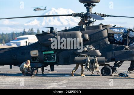 A soldier performs maintenance on an AH-64 Apache helicopter during ...