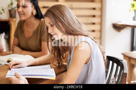 Happy group of friends studying and talking together at university ...