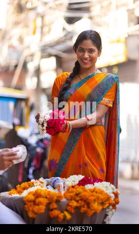 Happy woman buying flowers from street shop Stock Photo - Alamy