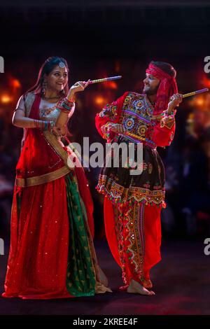 Gujrati couple performing Garba on stage Stock Photo - Alamy