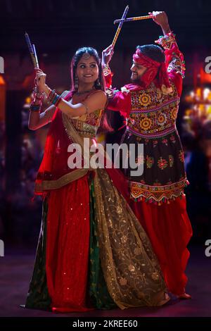 Gujrati couple performing Garba on stage Stock Photo - Alamy
