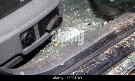 Shards of a windshield in a car after an accident on the road. Road ...