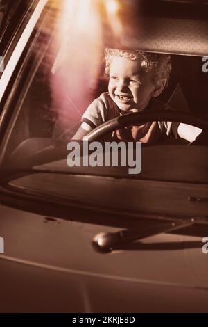 Little Driver. Cute little boy pretending to drive. Kid in car with his ...