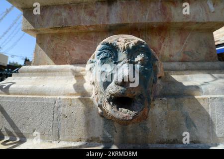 A gargoyle in shape of a human face of the water fountain built in 1903 ...