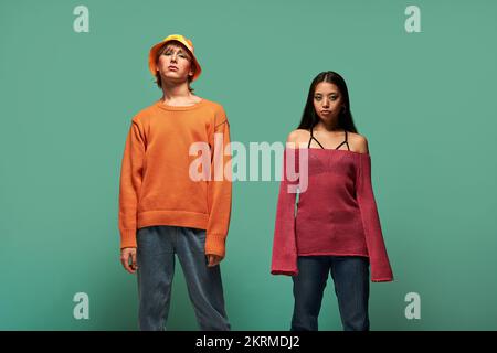 Diverse genderqueer models in colorful stylish clothes embracing each ...