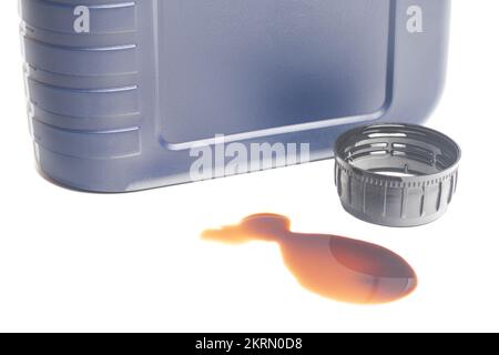 open engine oil bottle with a puddle of engine oil isolated on white ...