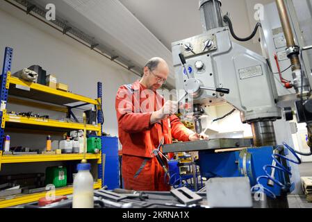 operator of a drilling machine in a industrieal company Stock Photo - Alamy