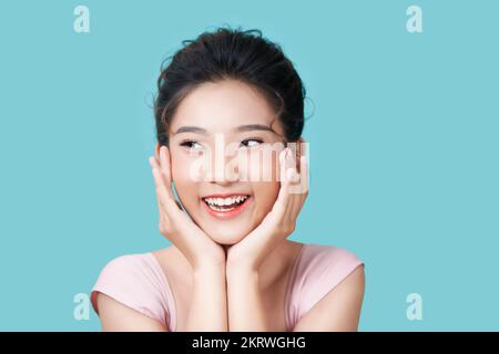 Portrait of an adorable woman with open palms near face having fun ...