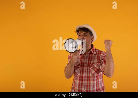 Mature man with megaphone loudspeaker sending a message to all who will ...