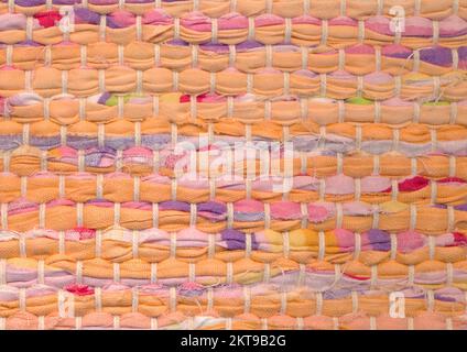 Closeup of handwoven rug rug in warm and bright pastel colors, plain ...