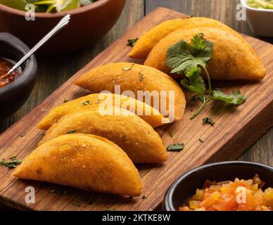 Fried empanadas with spicy sauce - Typical Colombian food Stock Photo ...