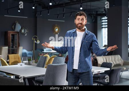 Confused bearded man shrugging, raising hands up and looking clueless ...