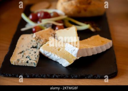 Tasting of fresh farmers scottish cheeses smoked cheddar, stilton, blue ...